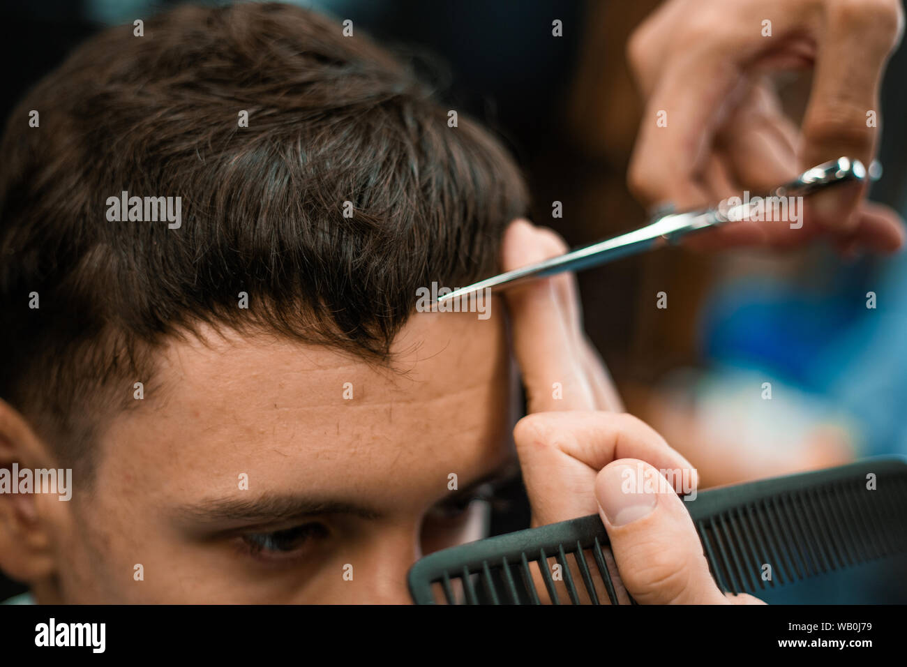 Barbershop. Close-up of man haircut, master does the hair styling in ...