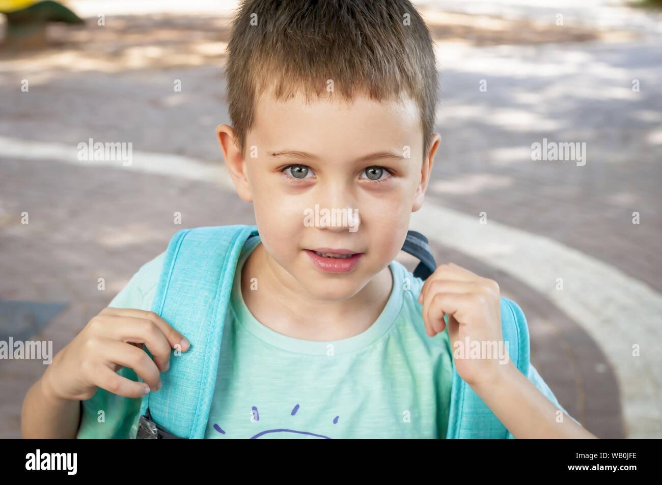 Cute 7 year old Caucasian child laughing, expecting to go to school for ...
