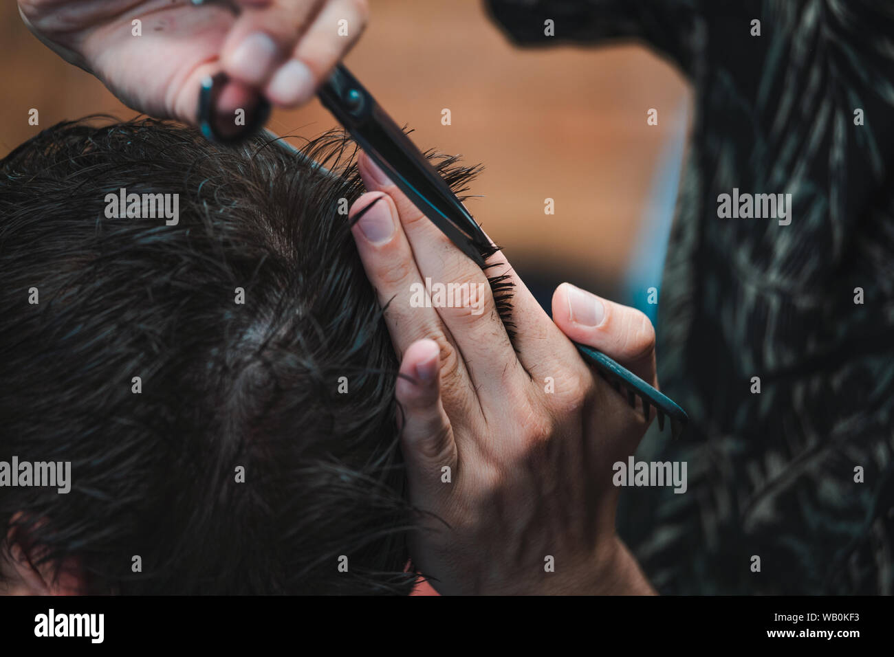 Barbershop. Close-up of man haircut, master does the hair styling in ...