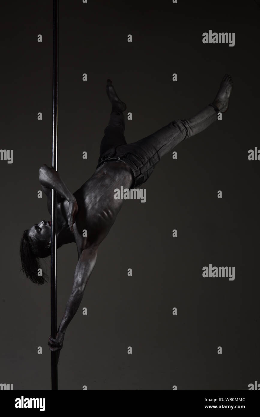 power and strength. power of silver man pylon dancer Stock Photo - Alamy