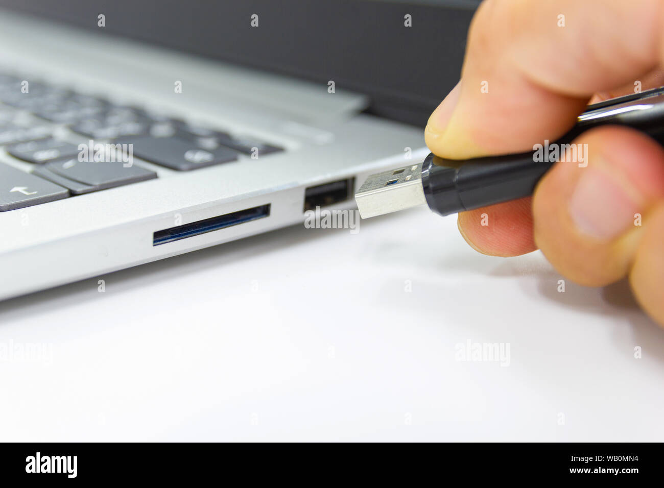 hand man hold Flash drive connect to USB port plug-in computer laptop ...