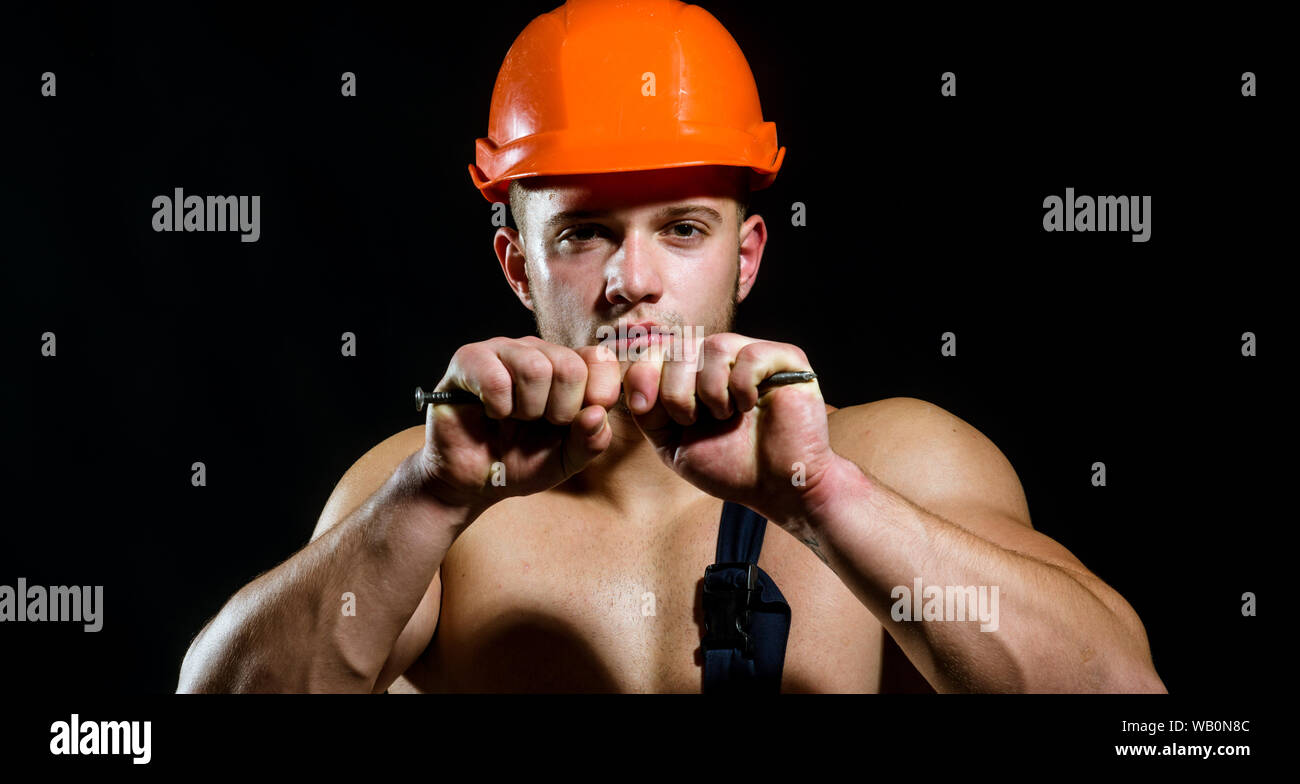 Showing his strength. Construction worker or builder with biceps ...