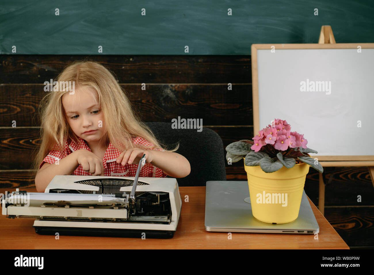 Little girl type research result on typewriter. Child typewrite ...