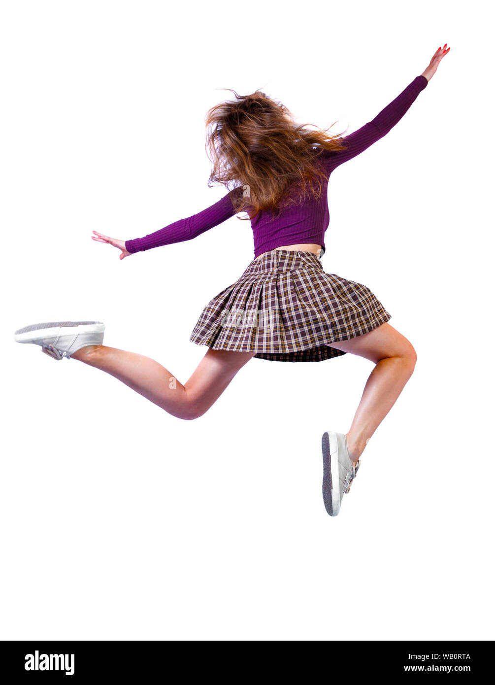 Back view of girl in a jump. Red-haired girl jumps. back side view of ...