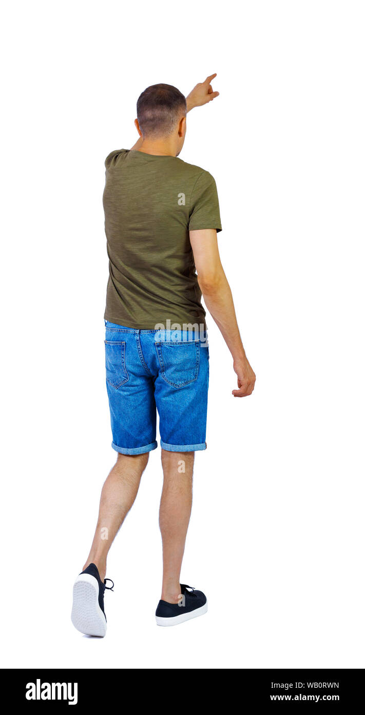 Back view of going pointing man in shorts. walking young guy . Rear ...