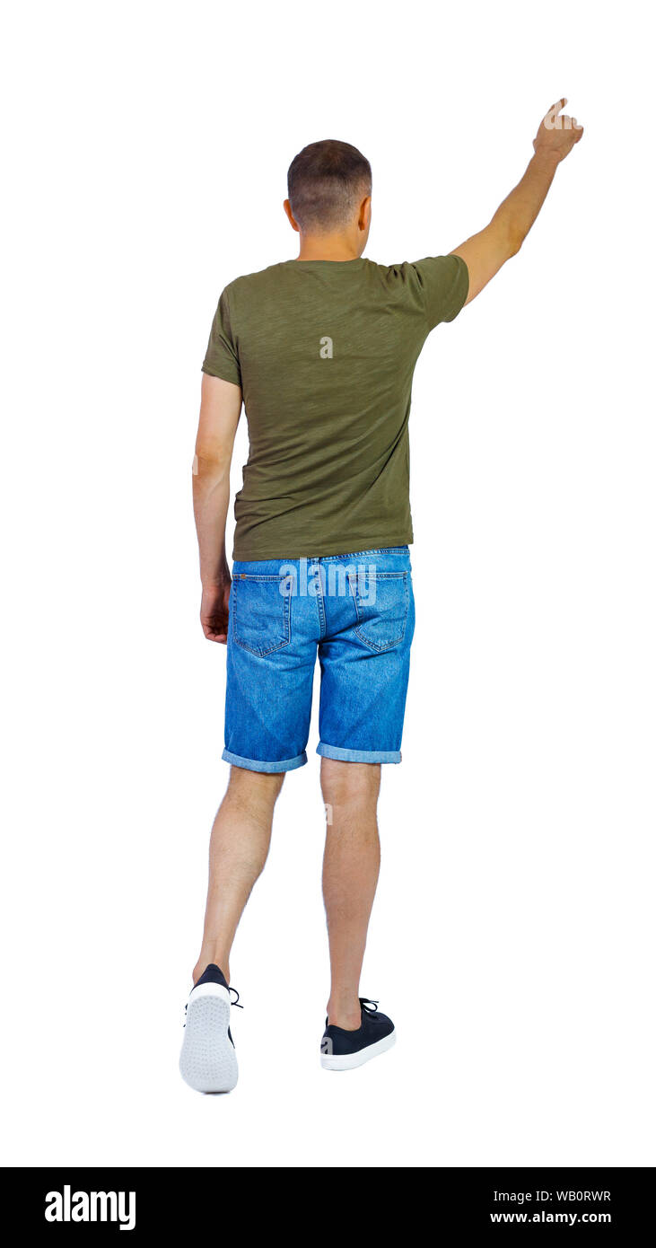 Back view of going pointing man in shorts. walking young guy . Rear ...