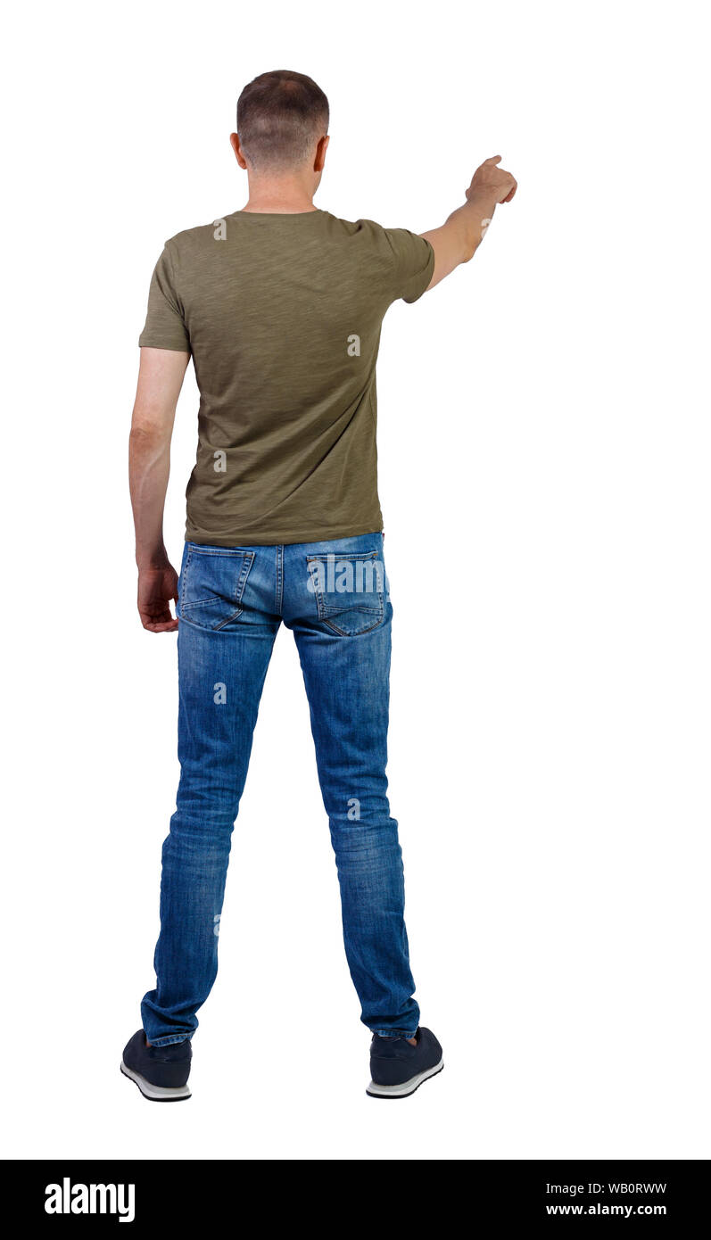 Back view of a man in jeans points his hand upwards. Rear view people ...