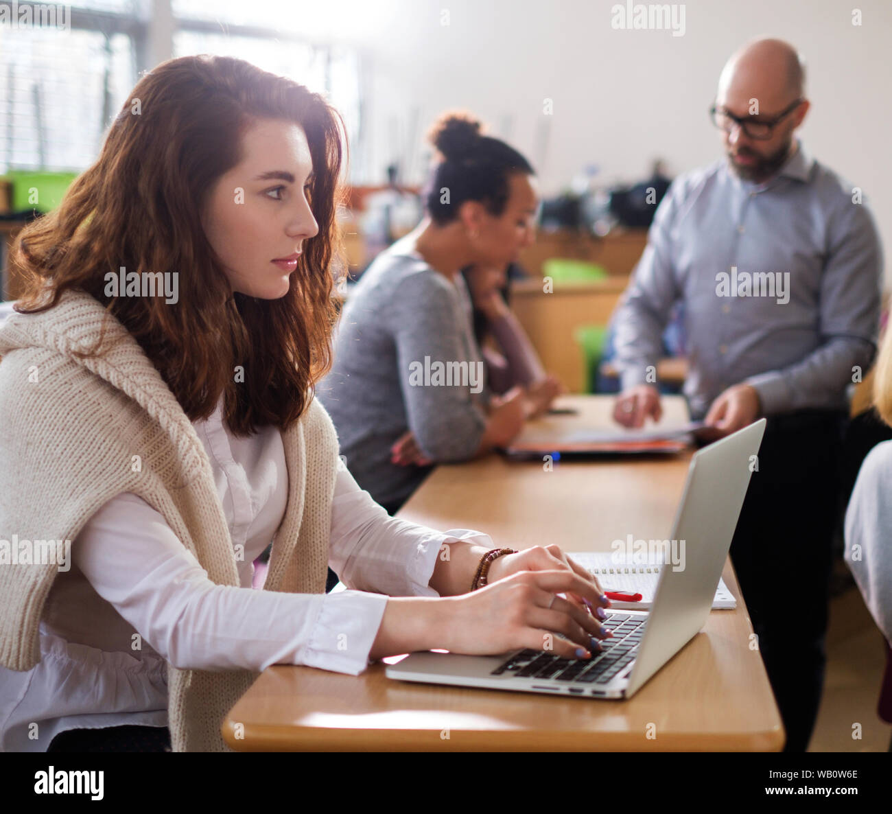 Beautiful girl taking notes in multinational group of students in an ...