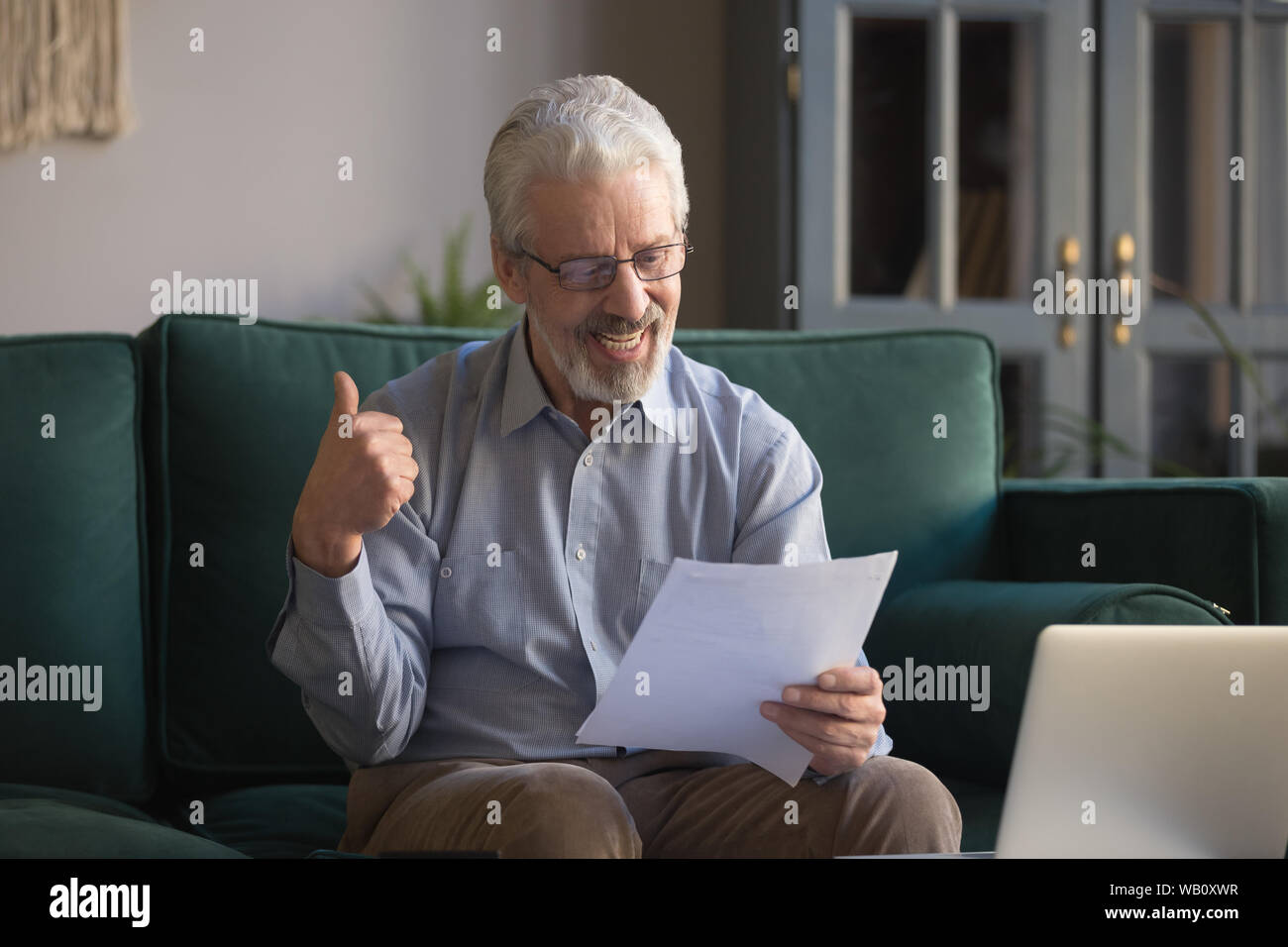 Happy pensioner reading mail hi-res stock photography and images - Alamy