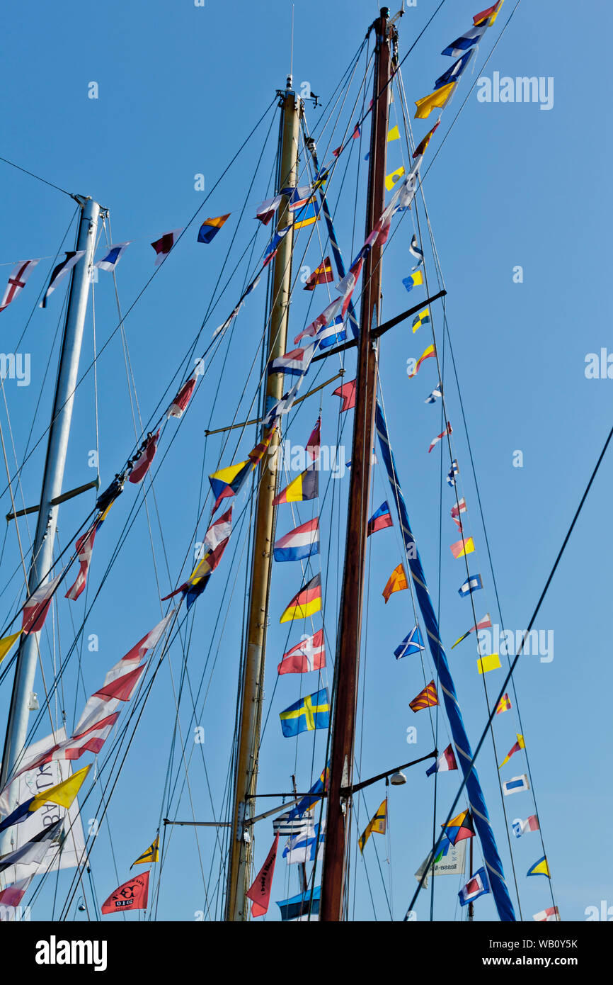 different international nautical flags on the mast of a sailing boat ...