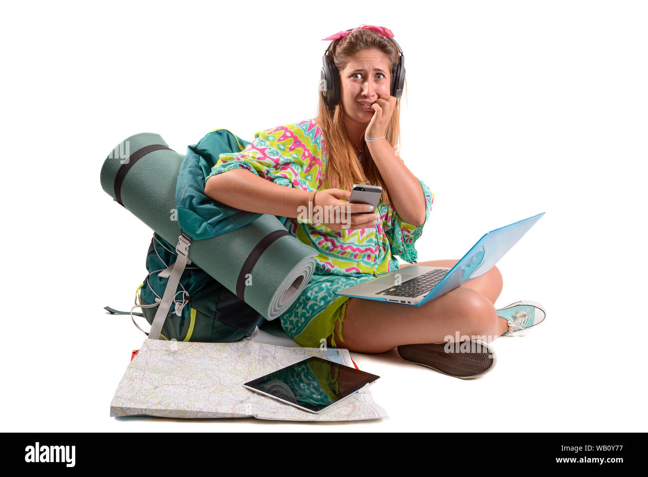 Lost and stressed girl with many devices looking for directions ...