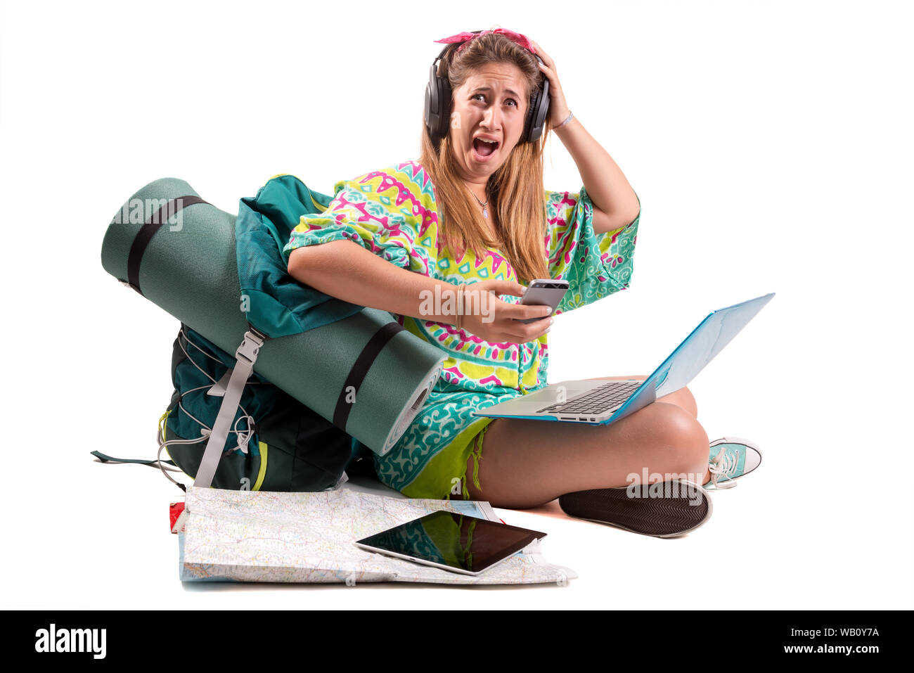 Lost and stressed girl with many devices looking for directions ...