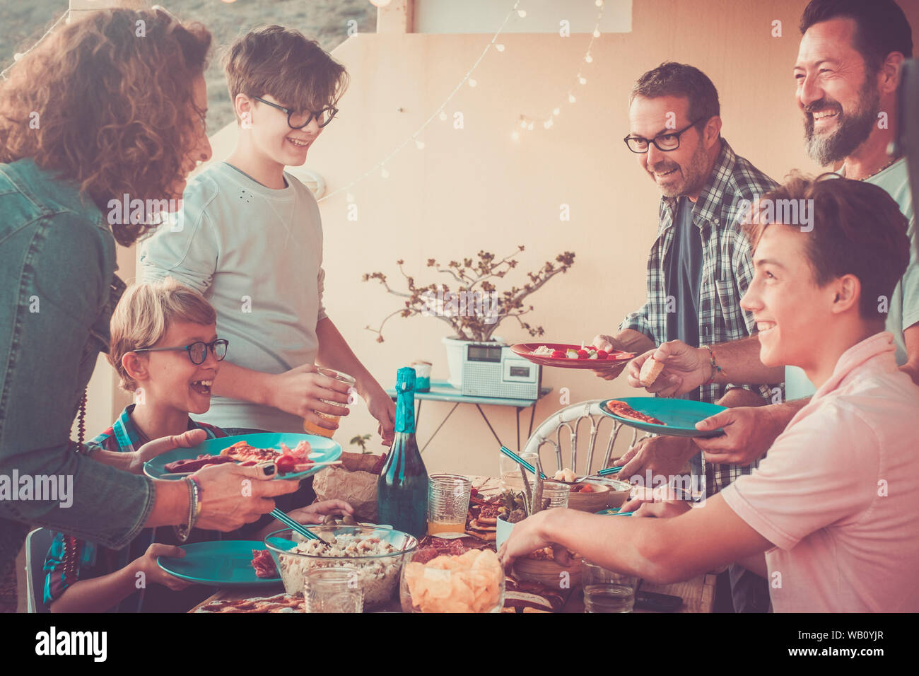 Mixed ages and generations people eating together in. friendship ...