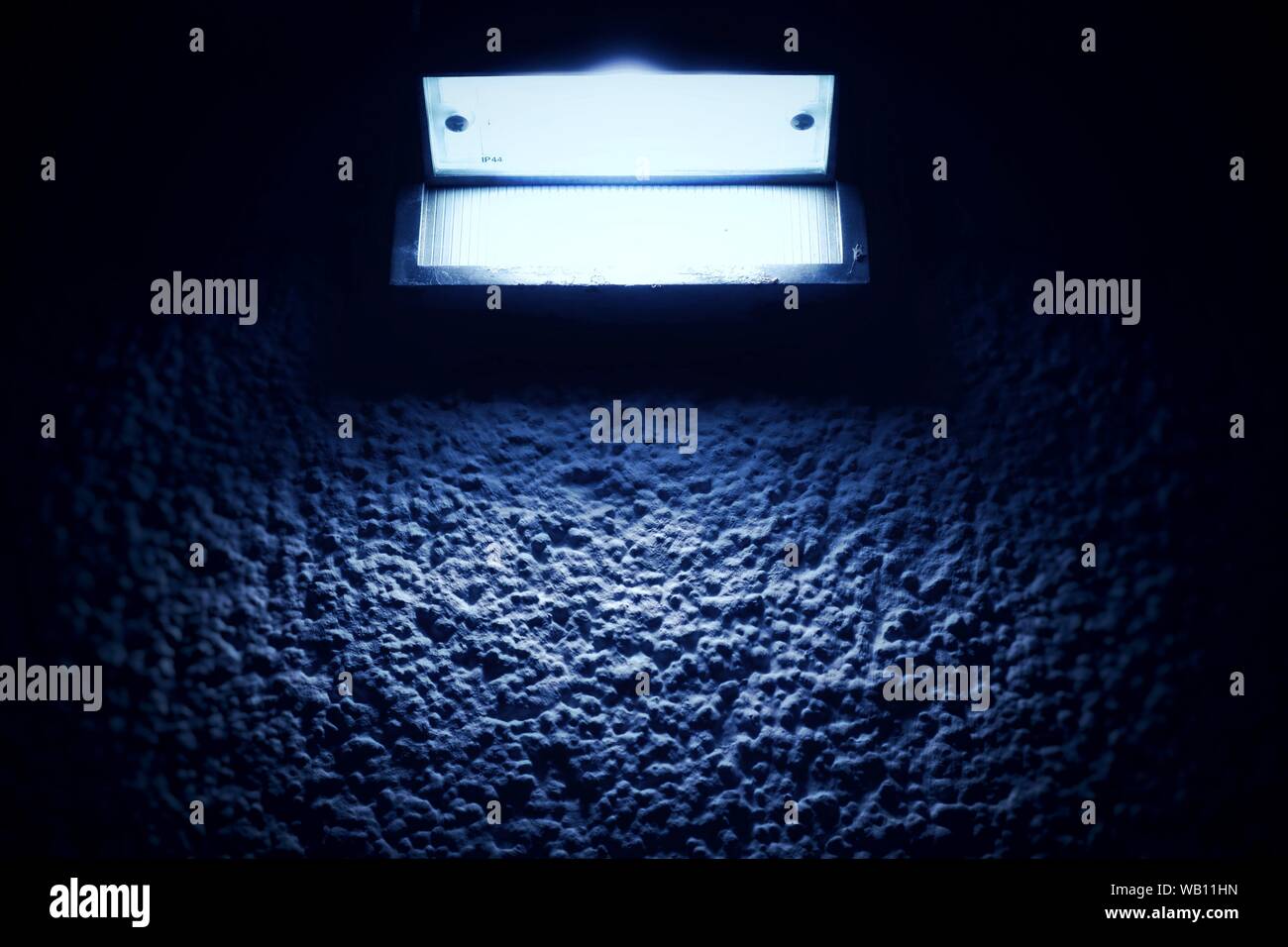 Bright Blue Light Illuminating an Outside Wall Stock Photo - Alamy