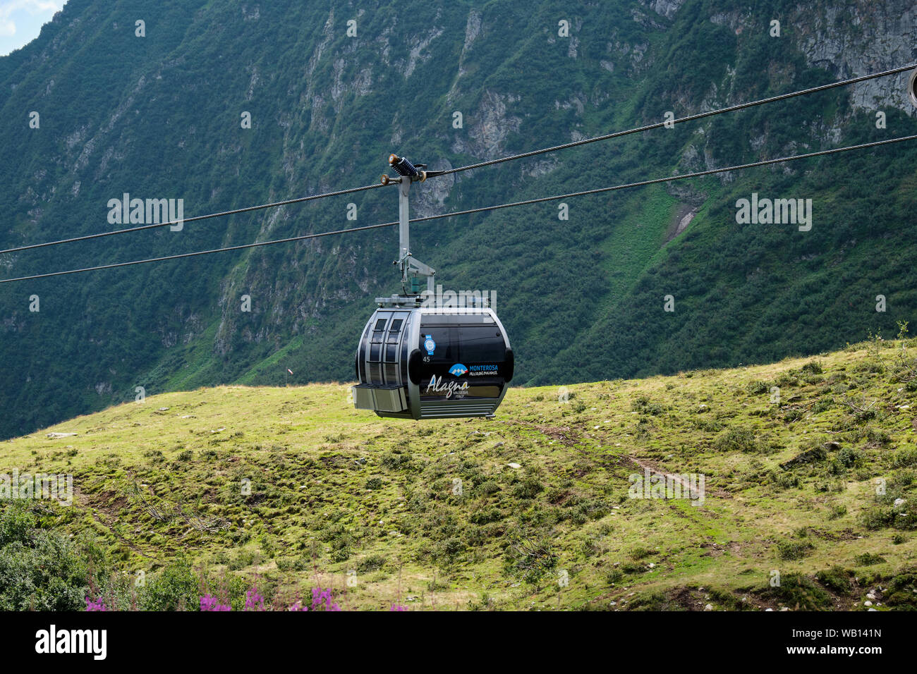 A scenic cable car flying over a Alagna town, famous for tourist ...