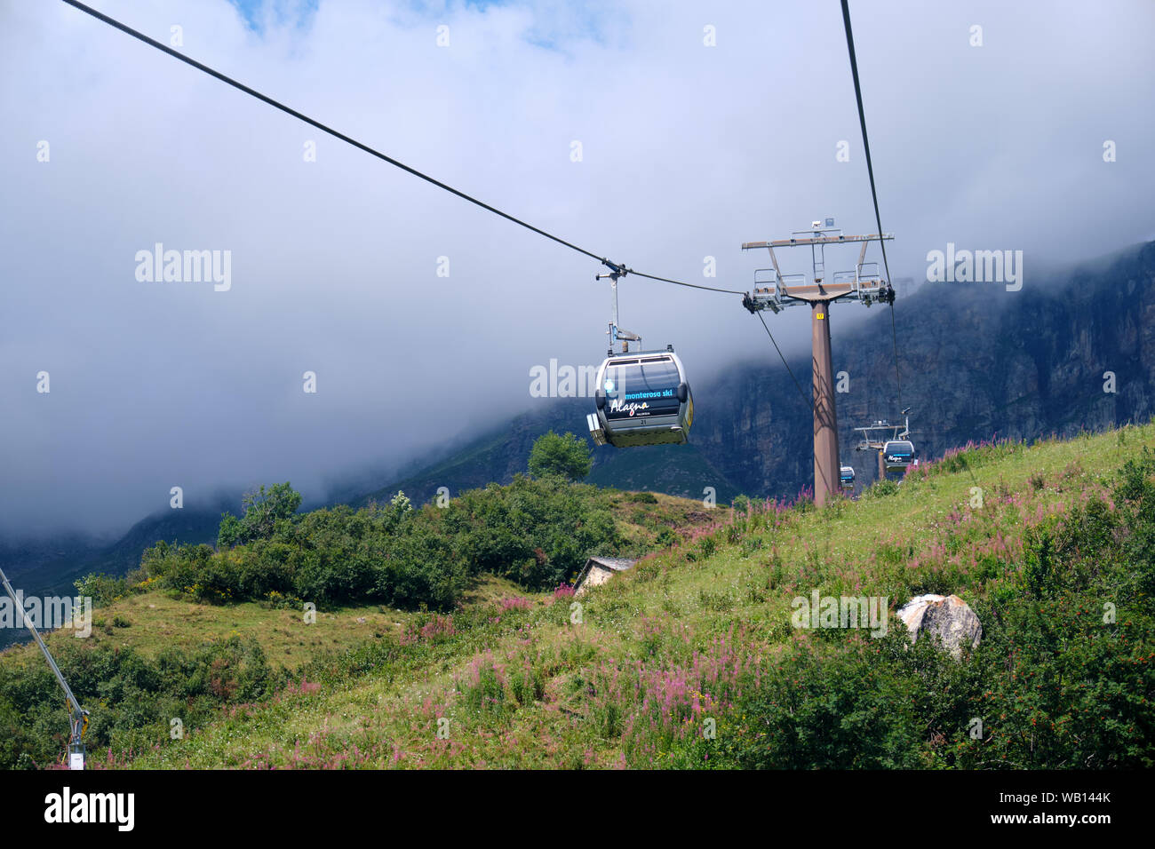 A scenic cable car flying over a Alagna town, famous for tourist ...