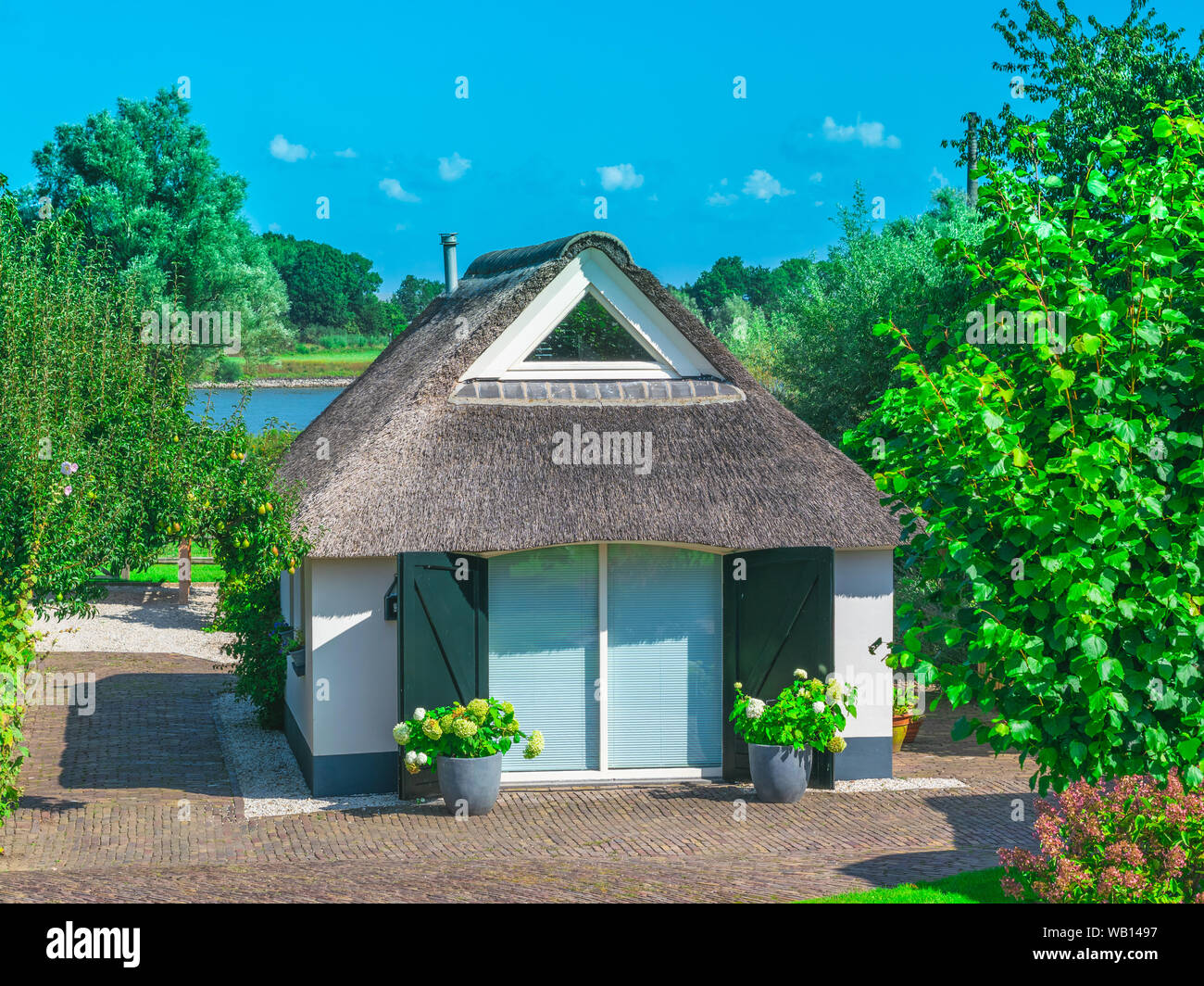 a traditional old Dutch house with a thatched roof in a typical Dutch ...