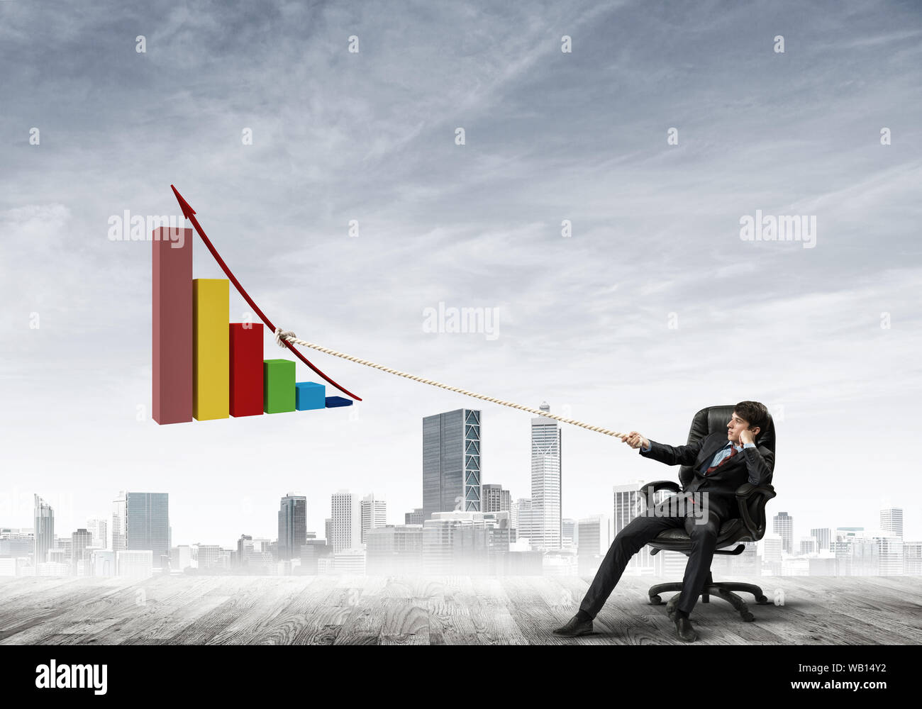 Young businessman outdoors making huge graph move Stock Photo - Alamy