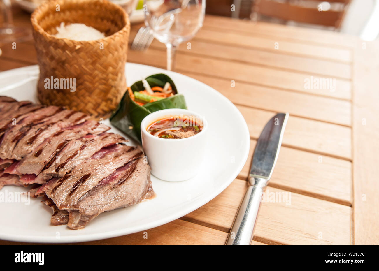 Thai style charcoal grilled beef with sticky rice and spicy sauce Stock ...