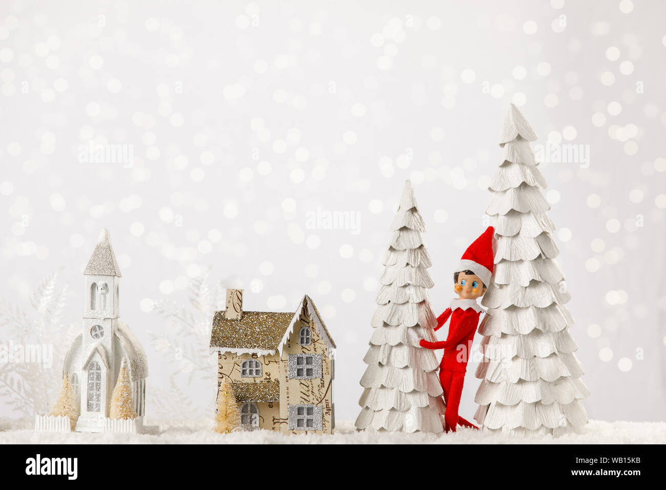 Happy children hiding behind tree hi-res stock photography and images ...