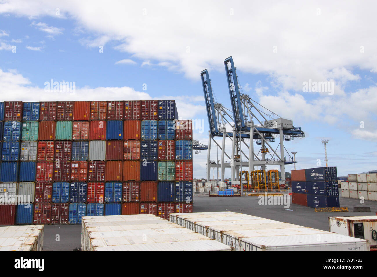 Stacked containers with big harbour cranes in the background | Harbour ...