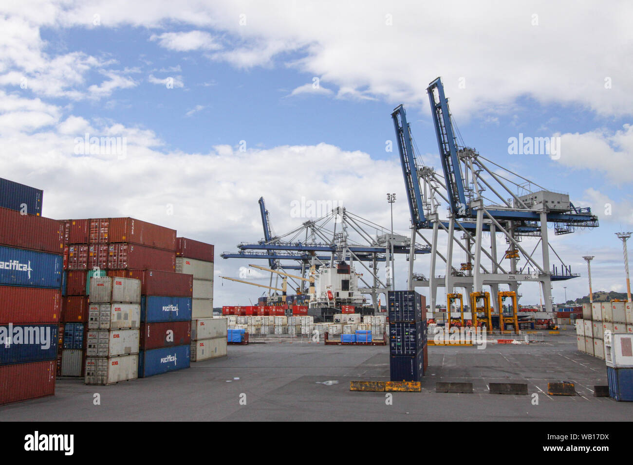 Stacked containers with big harbour cranes in the background | Harbour ...