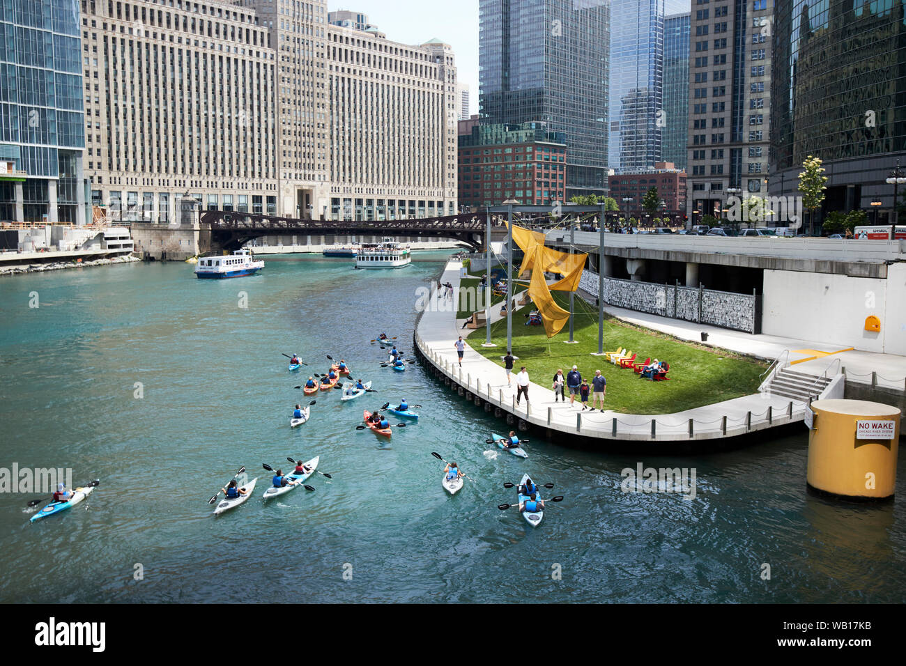 canoeists and chicago riverwalk at Wolf Point on the chicago river ...