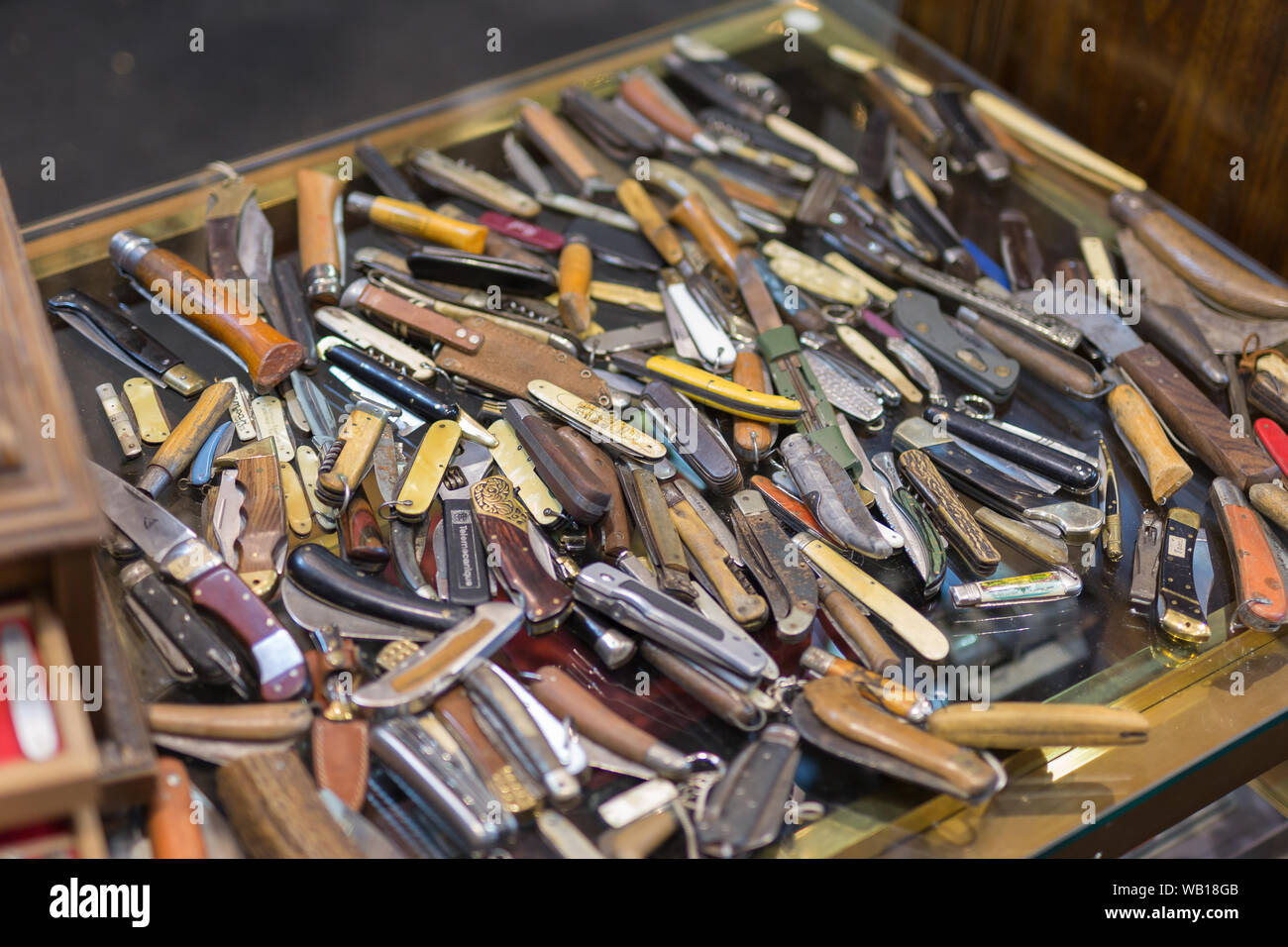 Collection of Coloured and Worn Knives with Folding Blade Scattered on ...