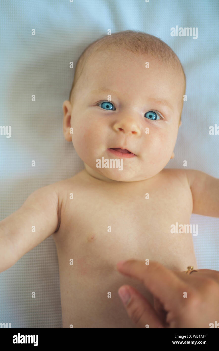 Happy newborn baby. Care stomach cramps for happy baby. Newborn girl or ...