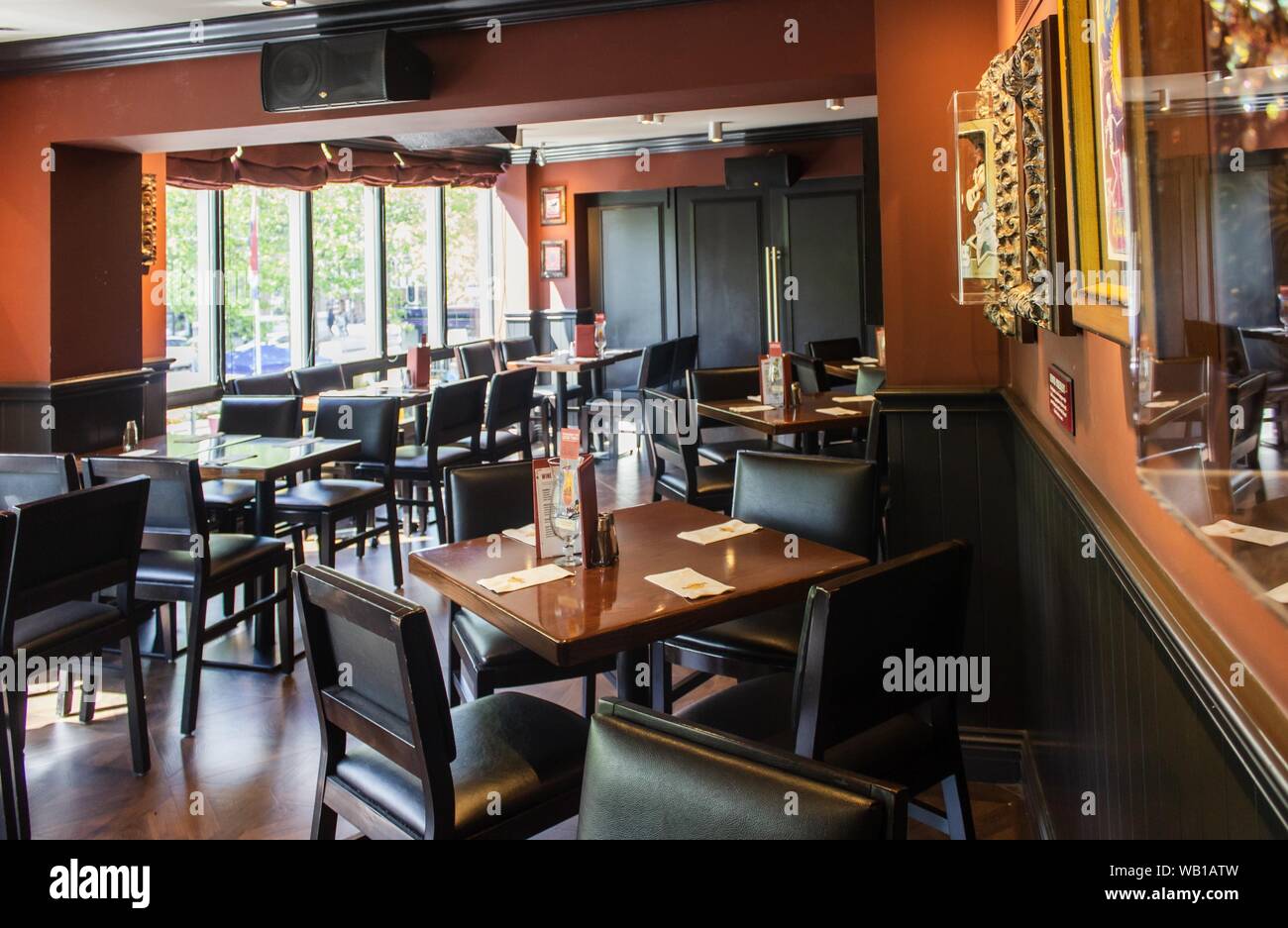 Interior shot of a cafe with brown walls and small tables Stock Photo ...