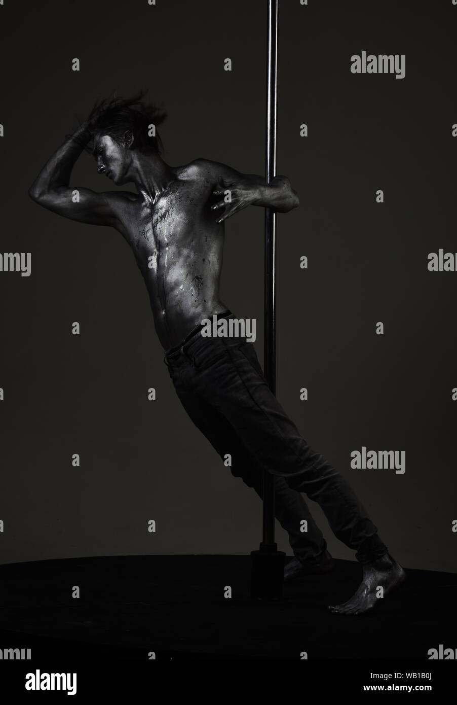 modern art installation. modern art of silver painted man on pylon ...