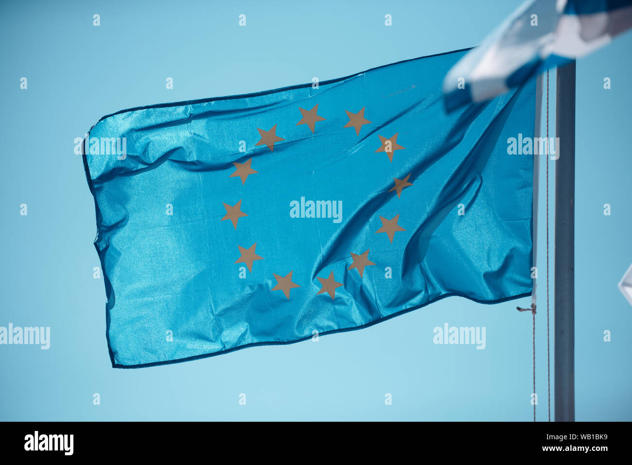 Flag of european union flying on background of blue sky. Symbol of ...