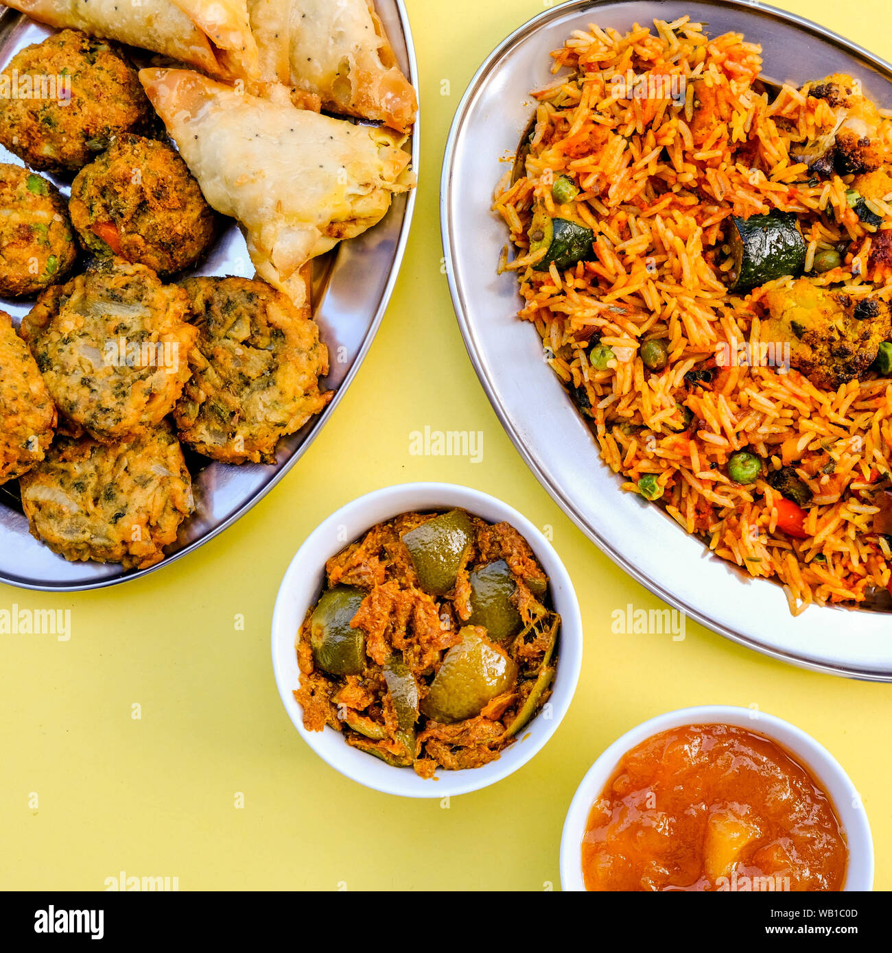 Indian Style Vegetable Biryani Meal With Pakoras, Samosas and Onion ...