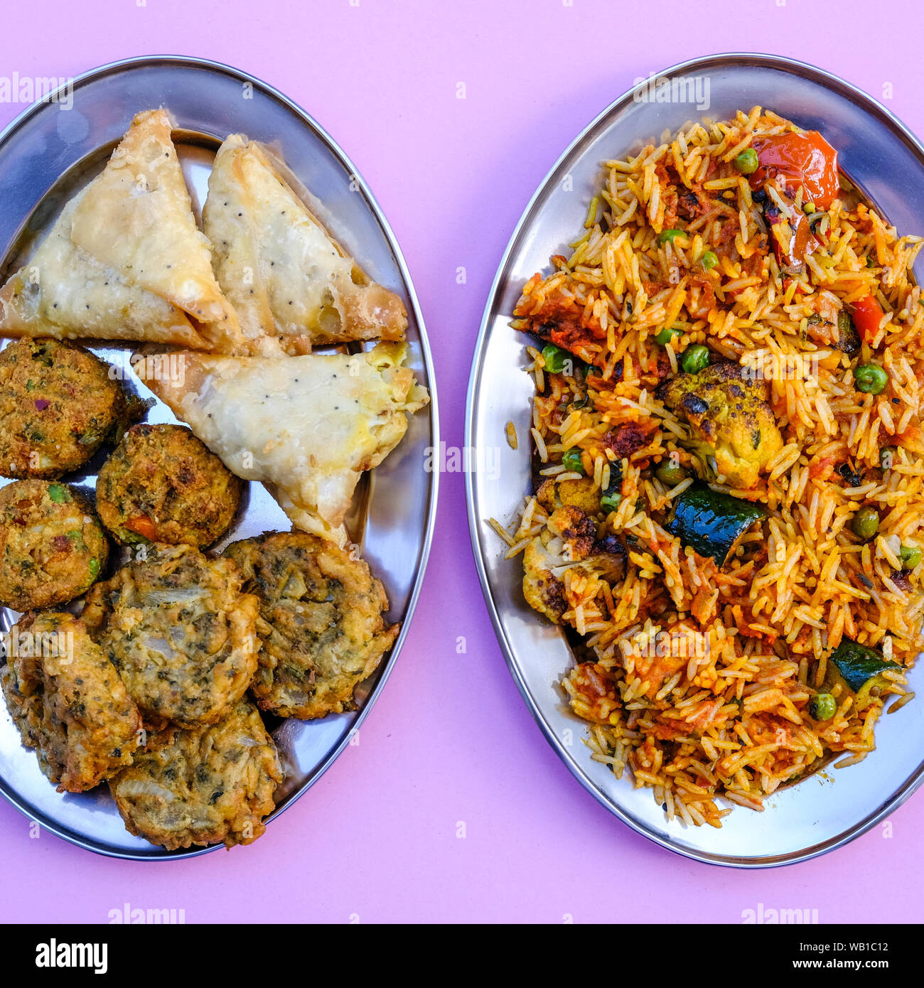 Indian Style Vegetable Biryani Meal With Pakoras, Samosas and Onion ...