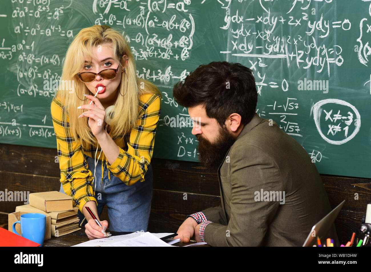 Students studying and testing lesson from teacher in classroom at ...