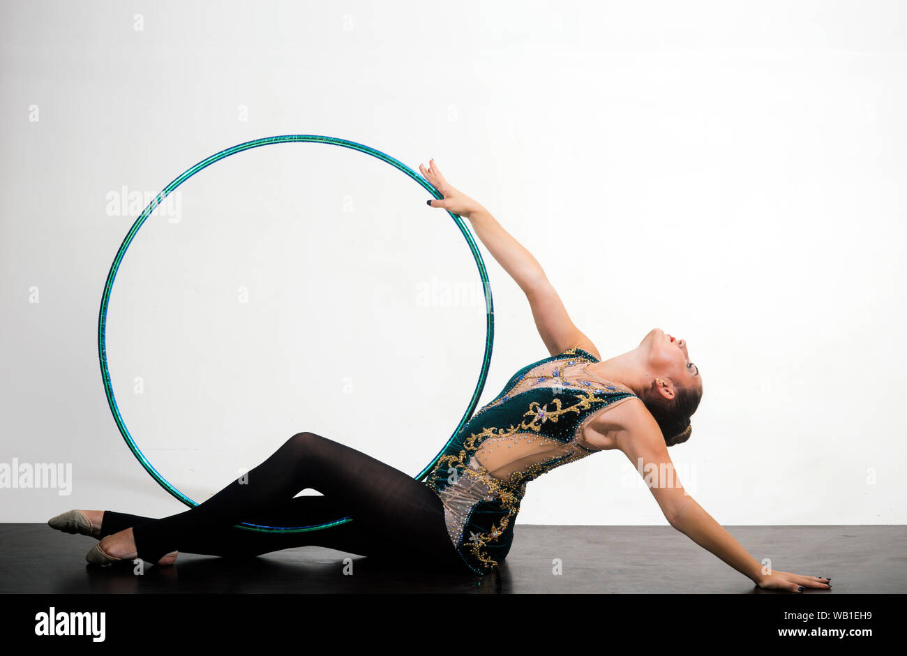 acrobatics with hula hoop of prety woman. acrobatics skills of cute ...