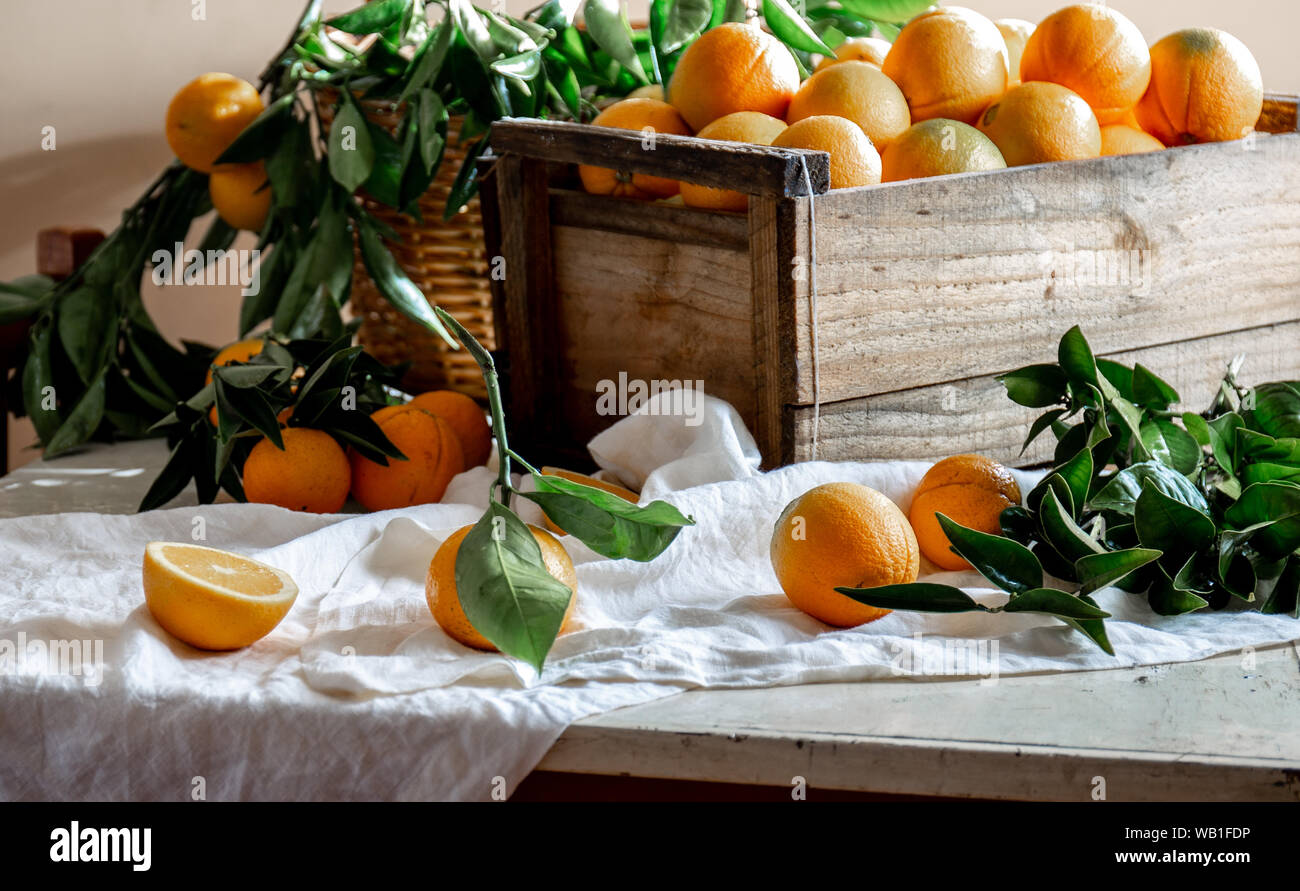 Table with box of fresh orange with orange tree branch and fresh orange ...