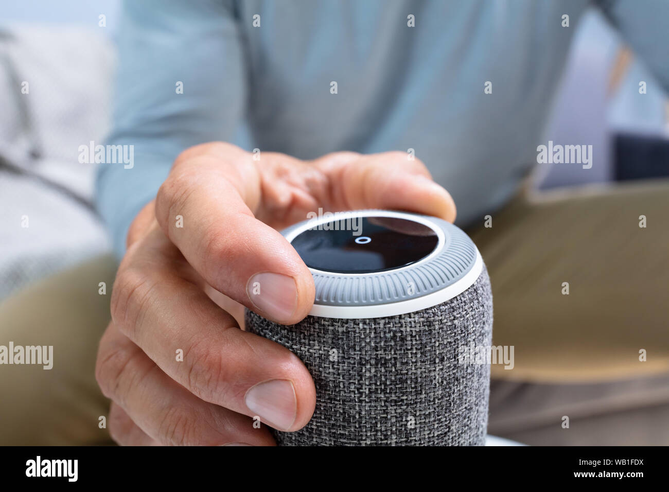 Man Adjusting Volume On Wireless Speaker At Home Stock Photo - Alamy