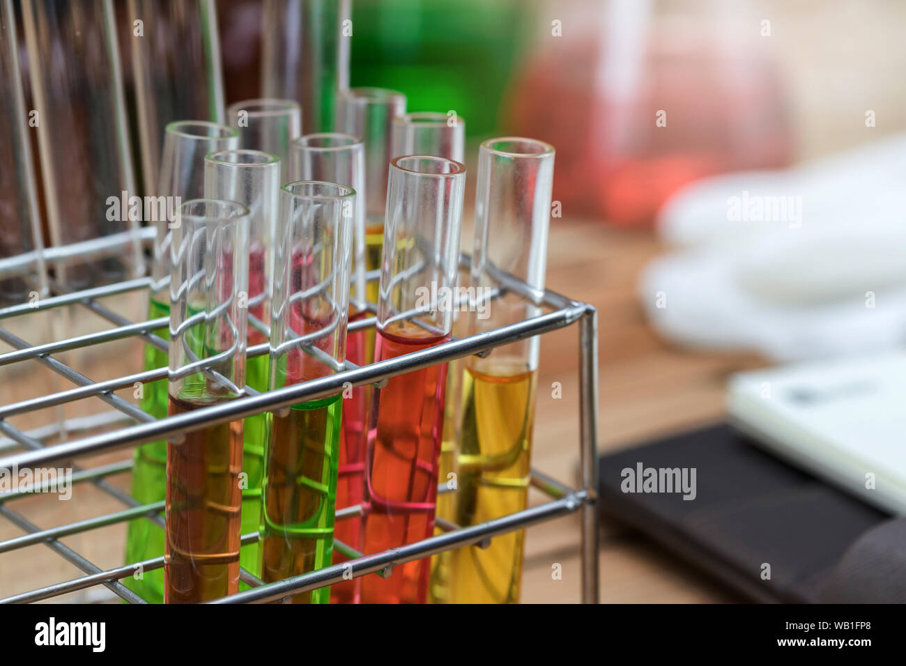 Stand with test tubes isolated on white. Several chemical solution in ...