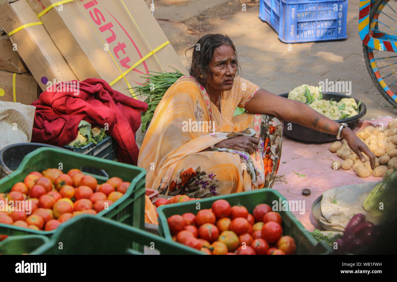 Indian vendor tends to their stall and produce at market, Sonauli ...