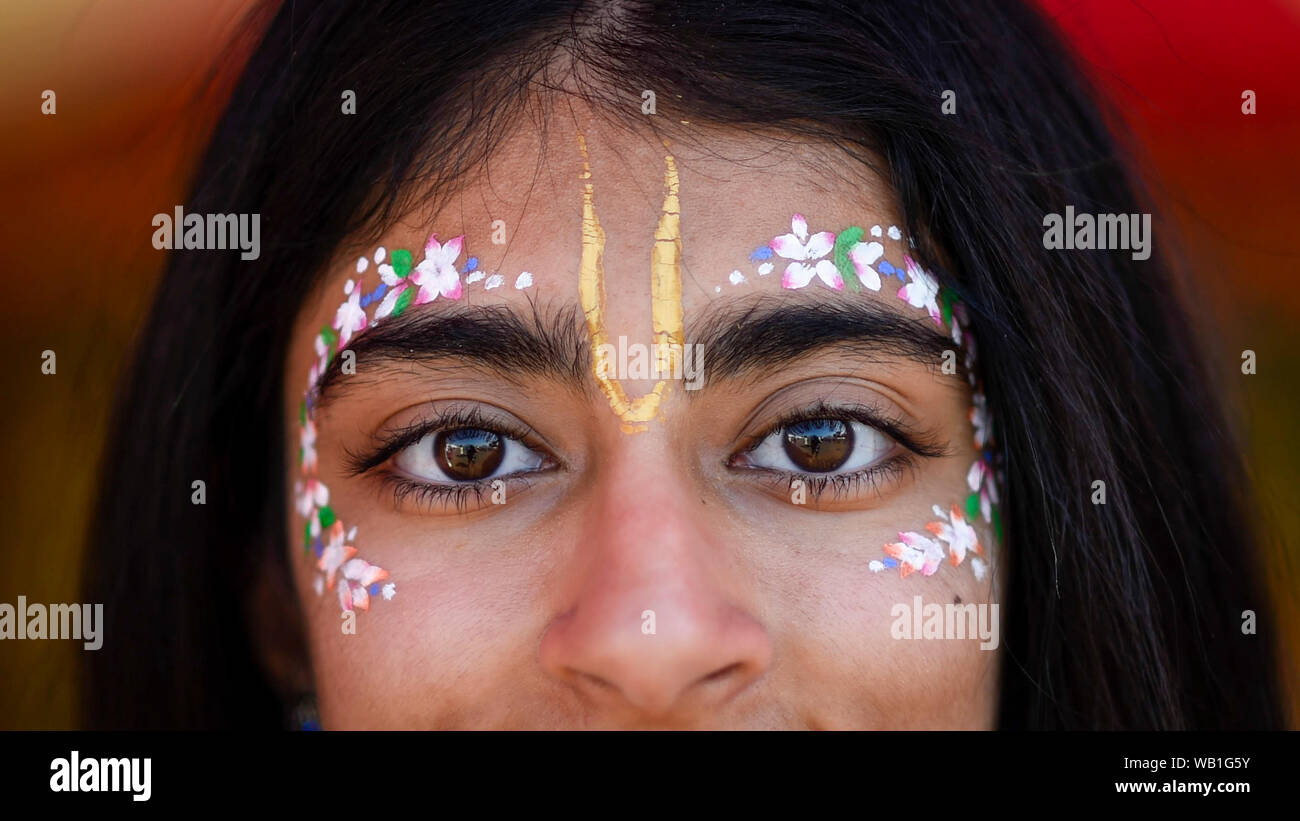 Watford, UK. 23 August 2019. A devotee wears gopi dots as thousands ...