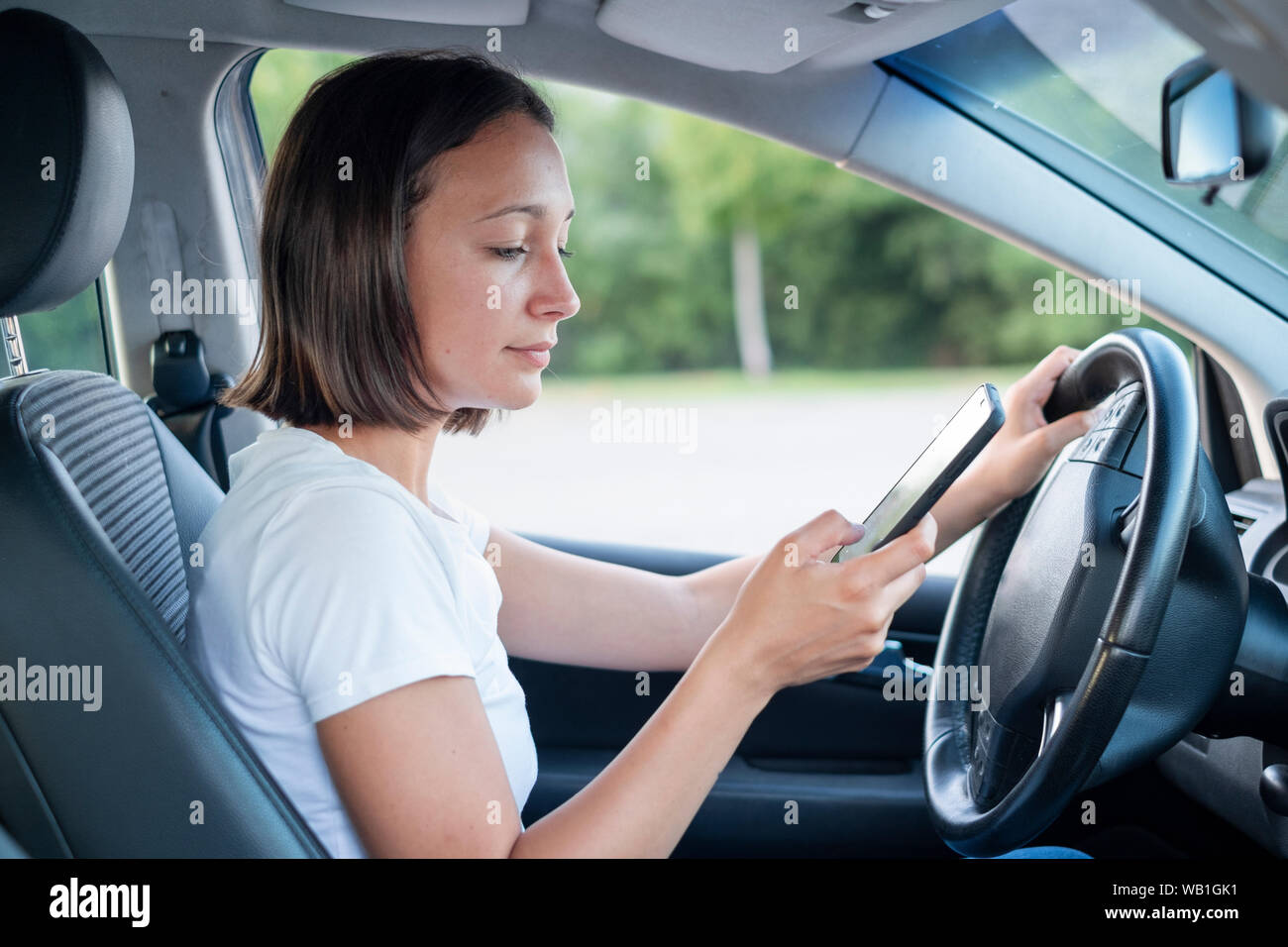 Woman reading text message rear view hi-res stock photography and ...