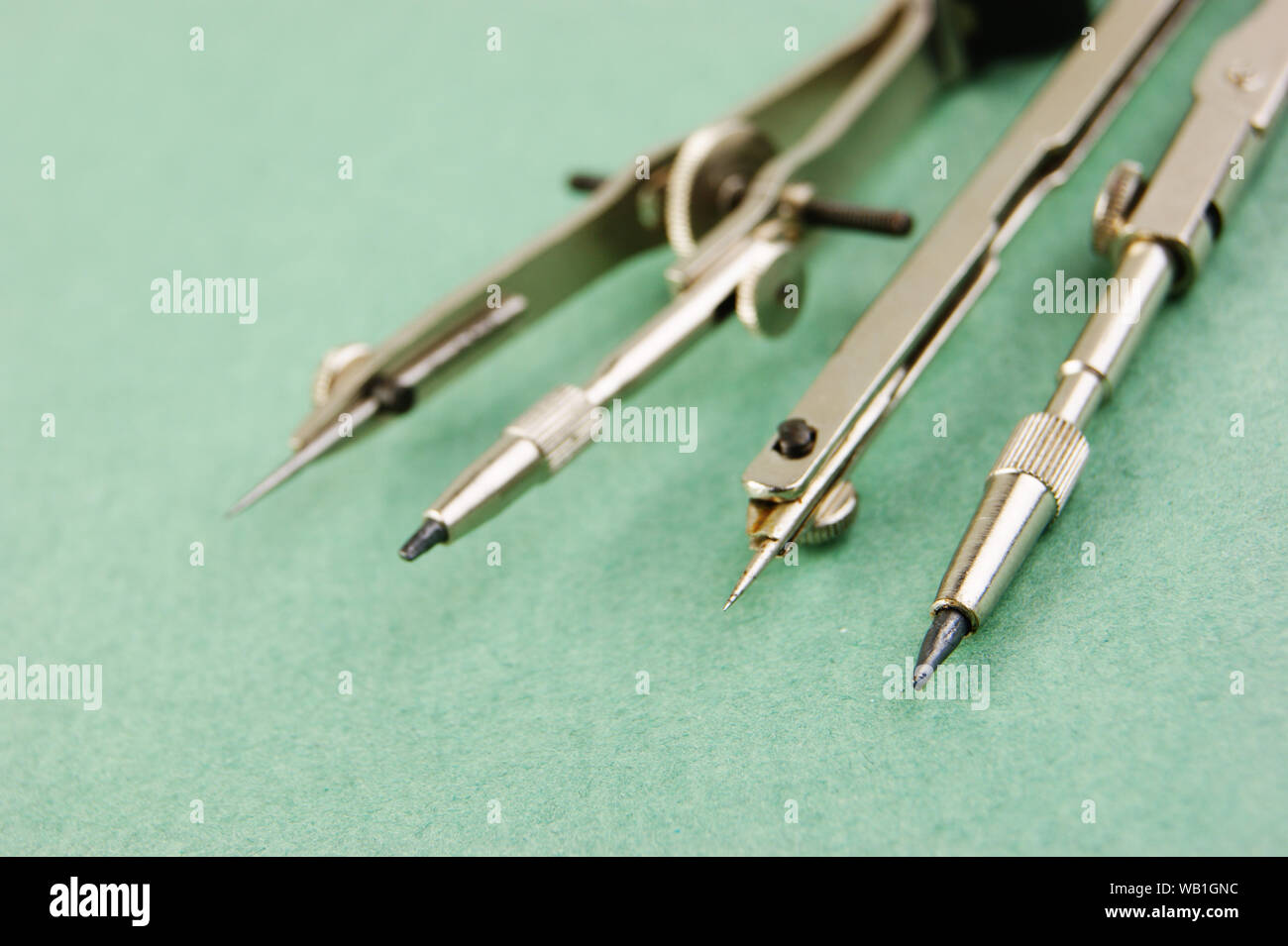 Old drawing tools on a green background Stock Photo - Alamy