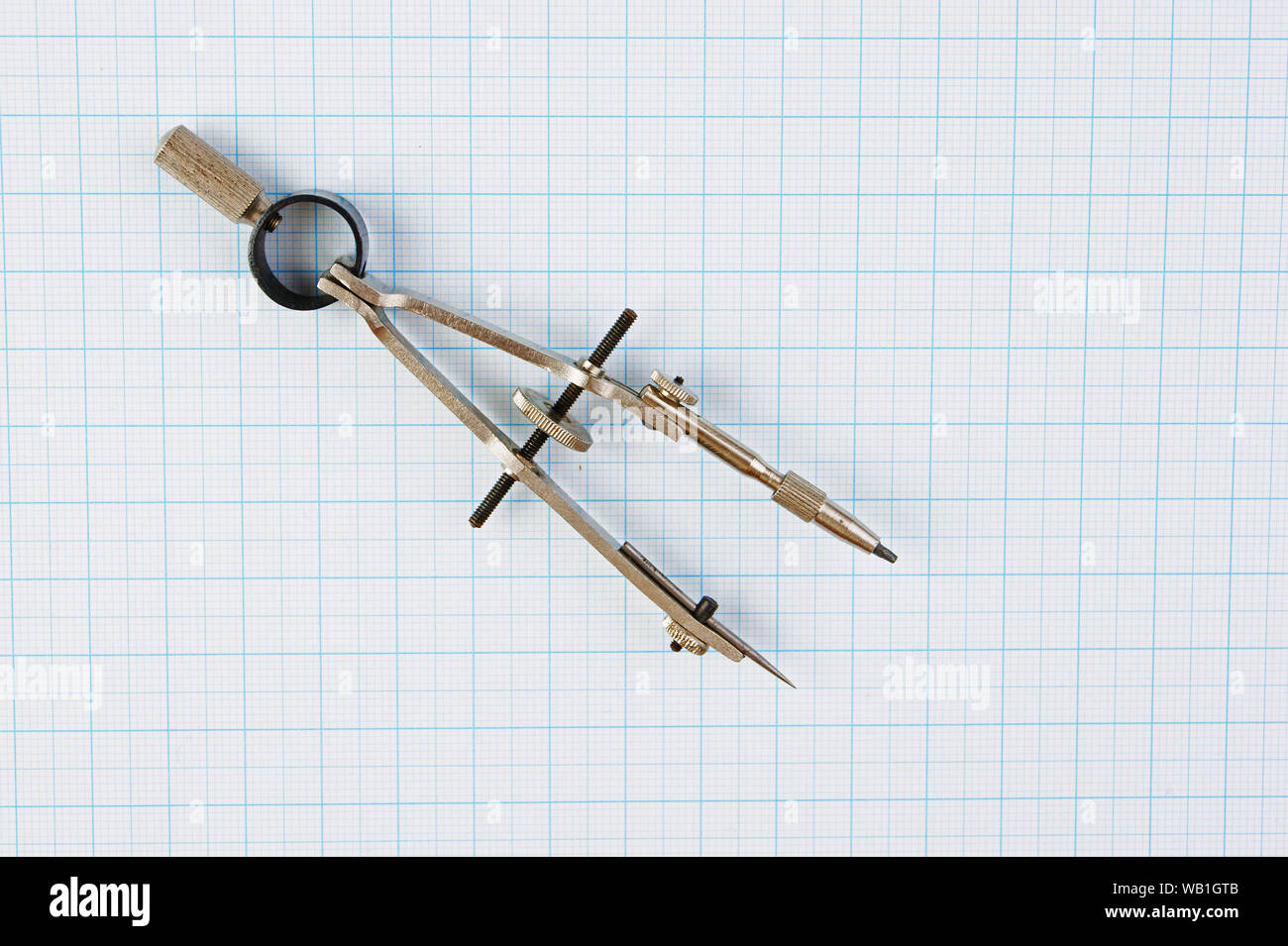 Old drawing tools on graph paper Stock Photo - Alamy