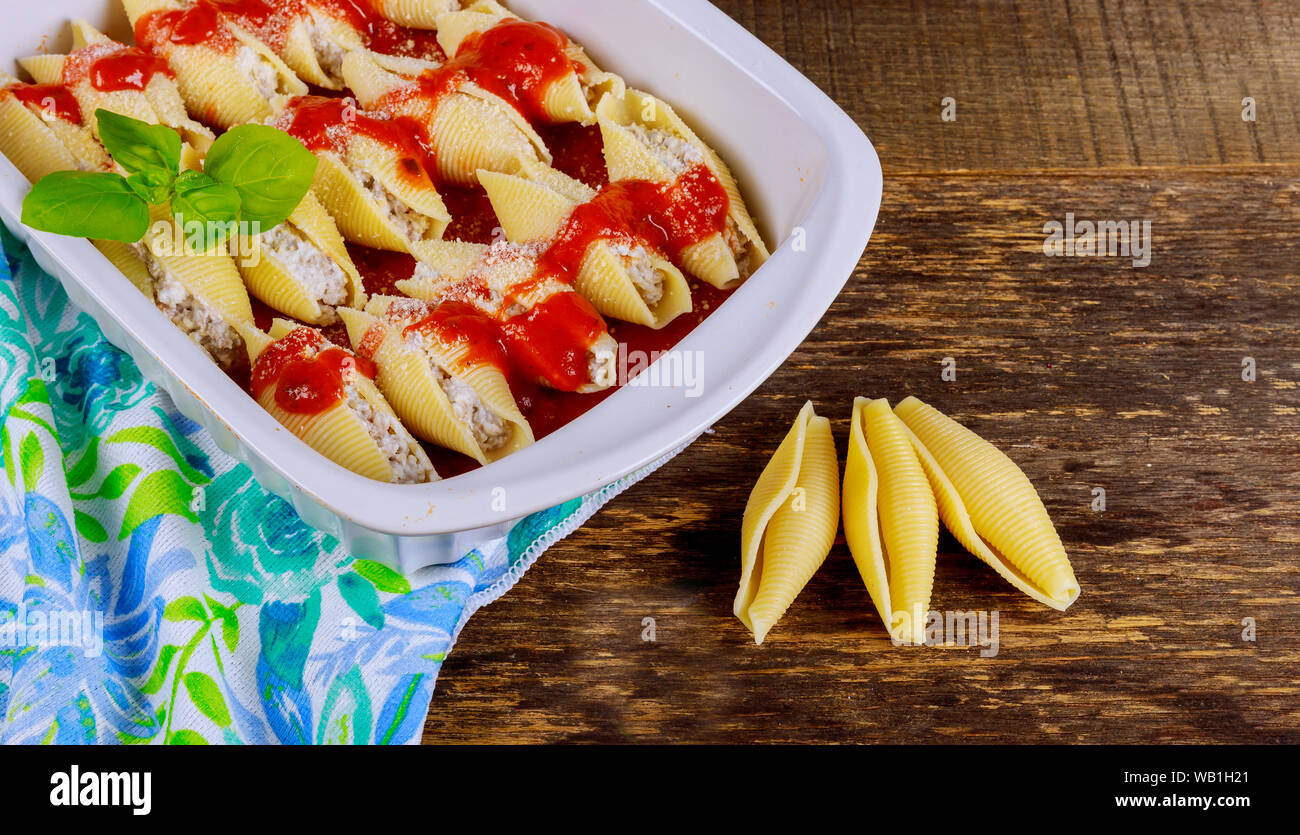 Pasta shells stuffed with cheese and mushroom, sprinkled with parmesan ...