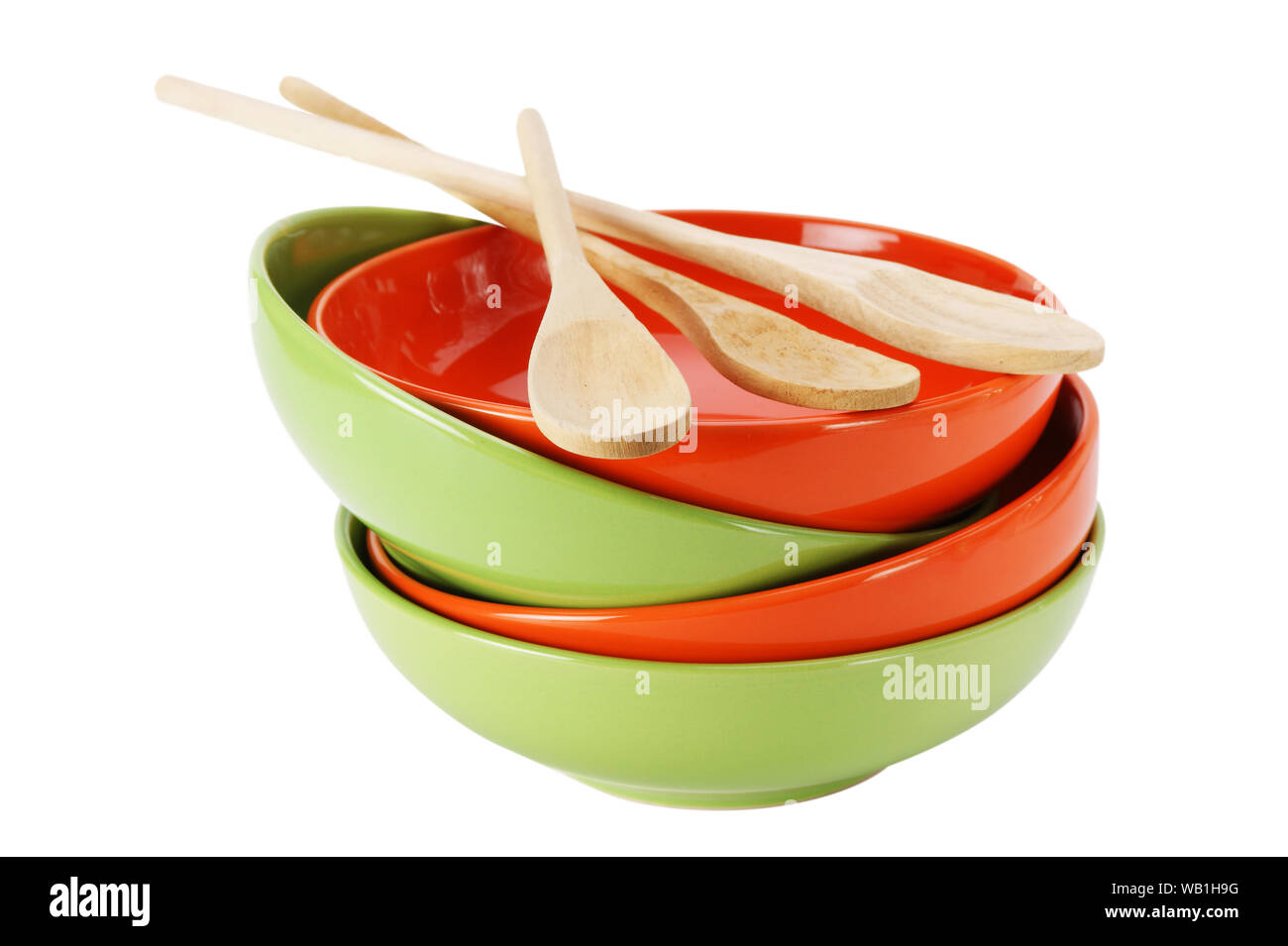 stack of clean empty plates and wooden spoons isolated on white ...