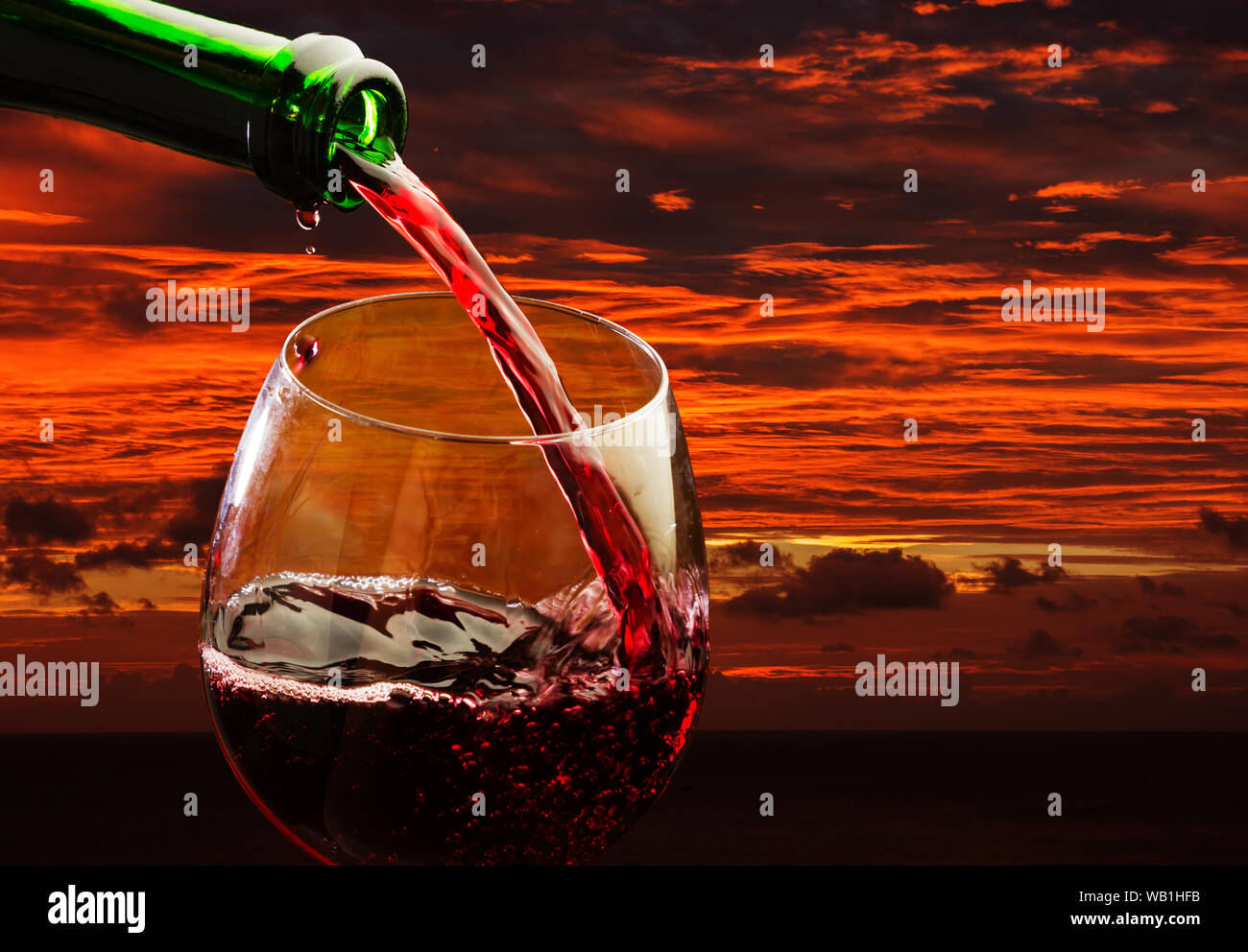 Red wine being poured into wine glass Stock Photo - Alamy
