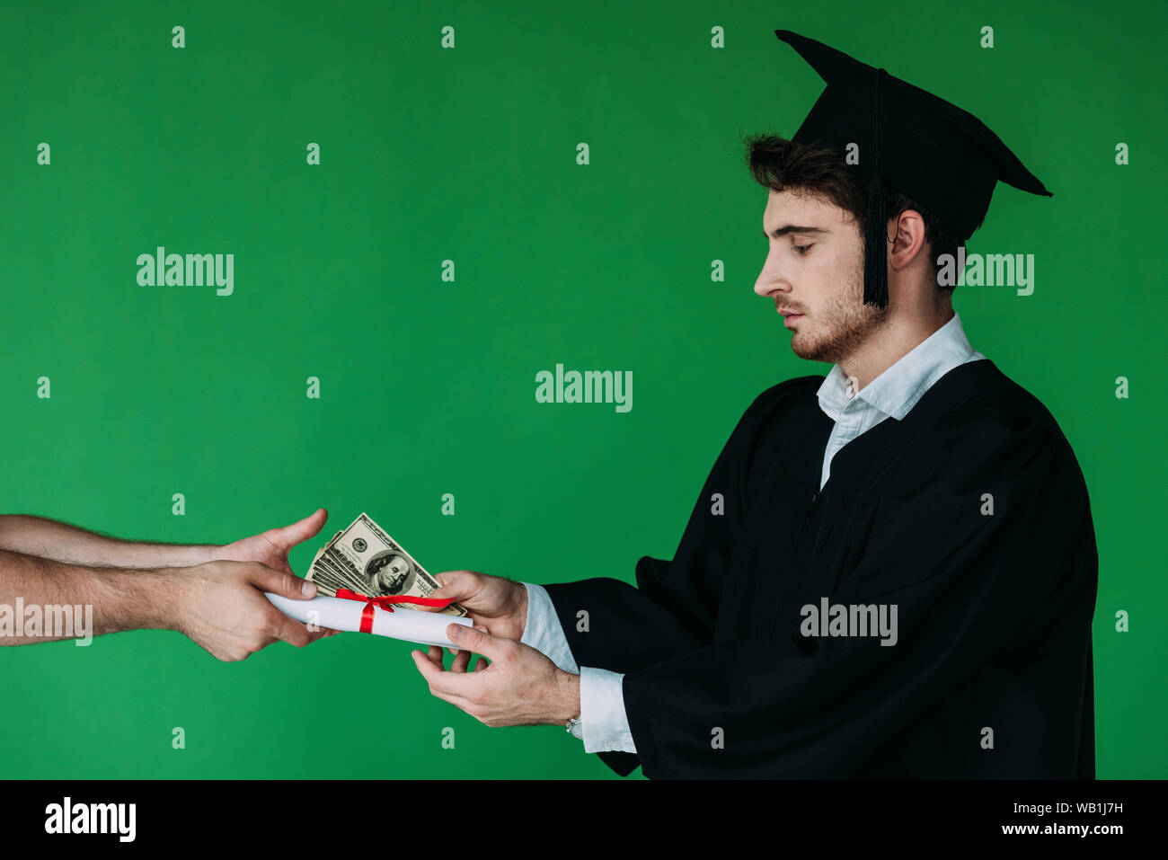 student in academic cap holding diploma with red ribbon and offering ...