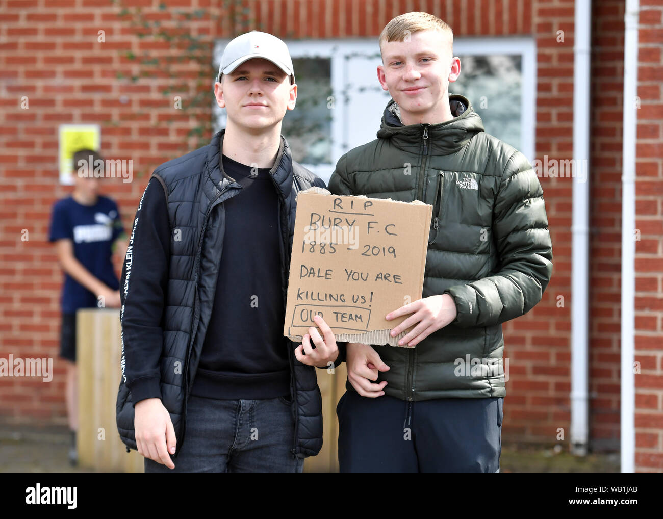 Bury fans hold up signage with a message to owner Steve Dale at Gigg ...