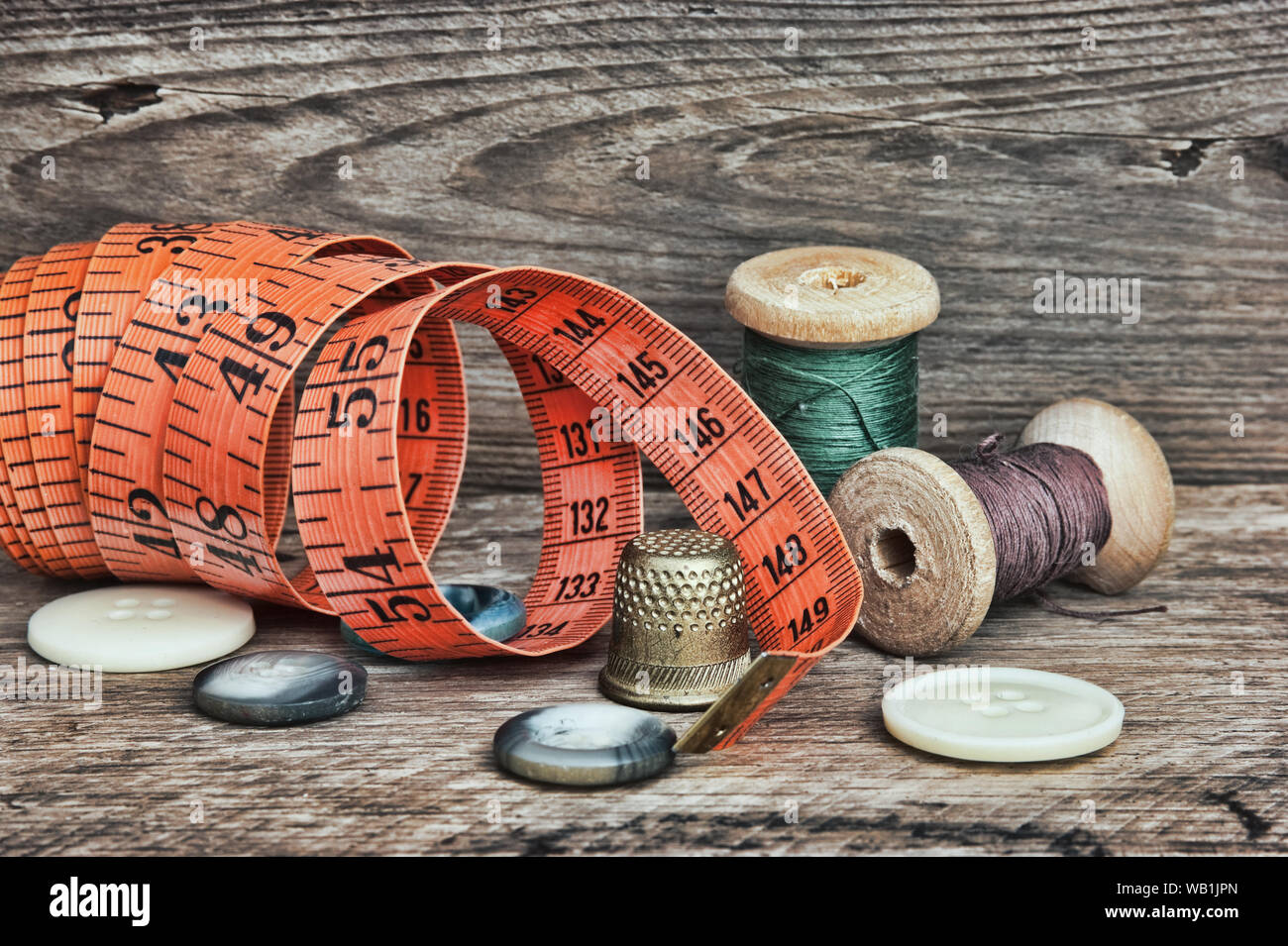 still life of spools of thread on a wooden background Stock Photo - Alamy